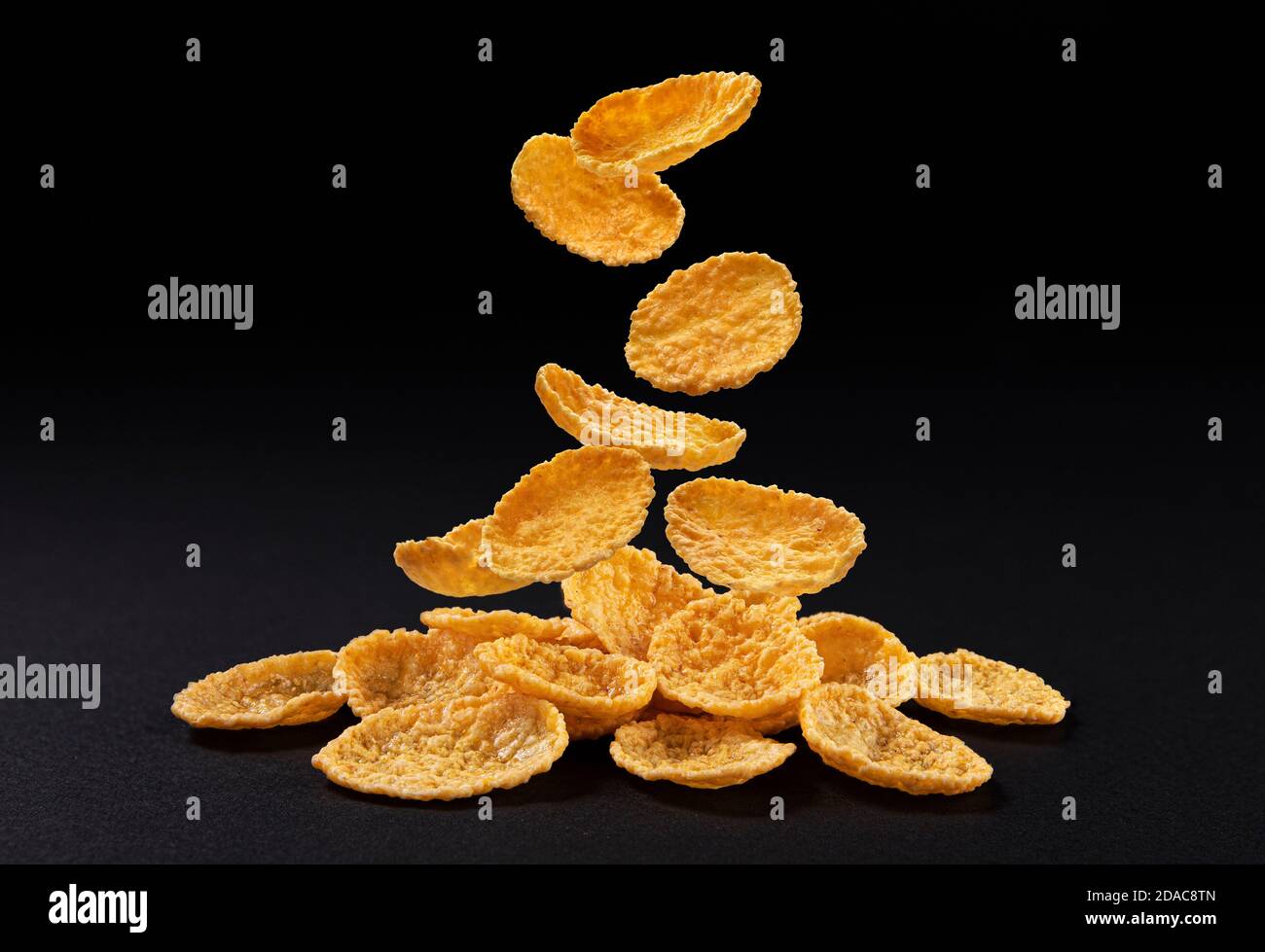 Falling corn flakes on black background, full depth of field Stock ...