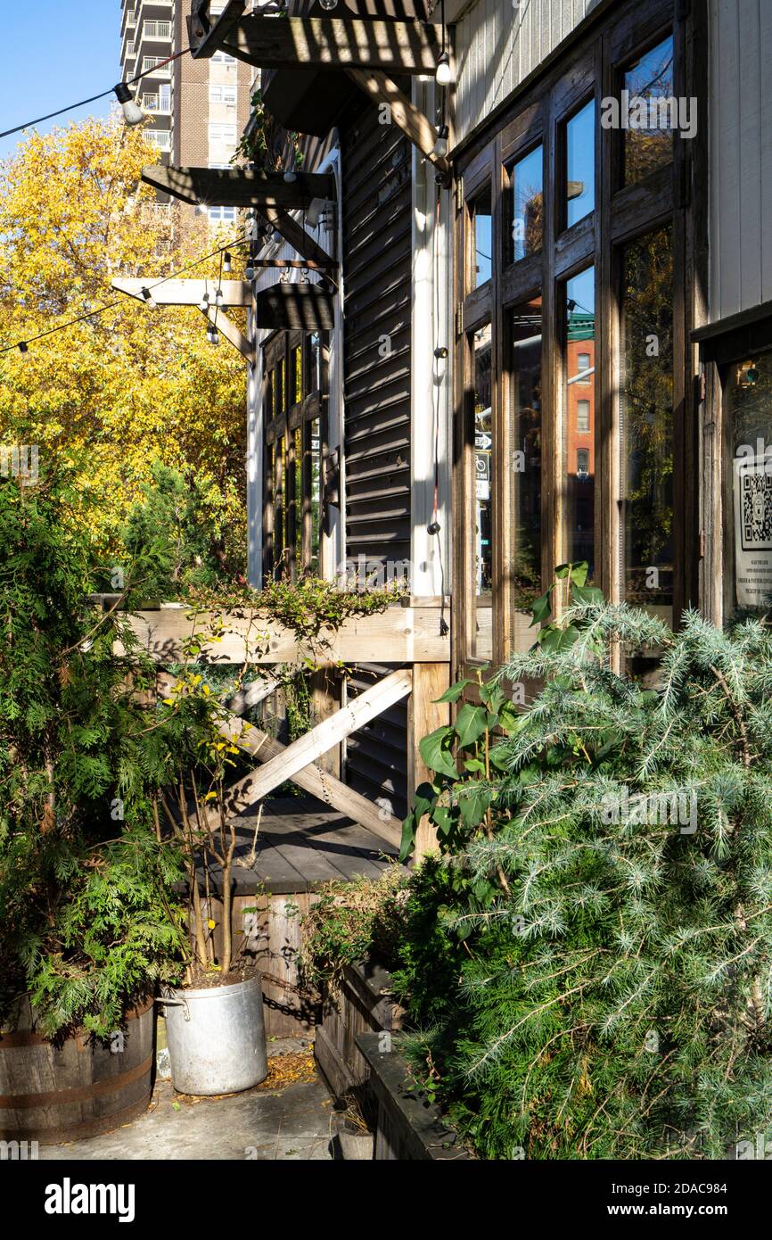 Facade of an old wooden building in the middle of the city, with lots ...