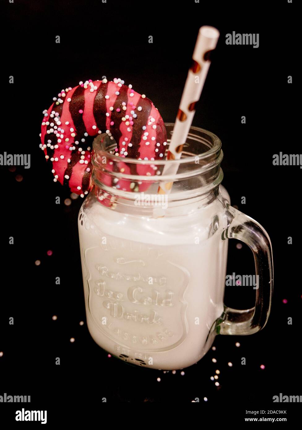 Vertical high angle shot of a milkshake on a black background Stock ...