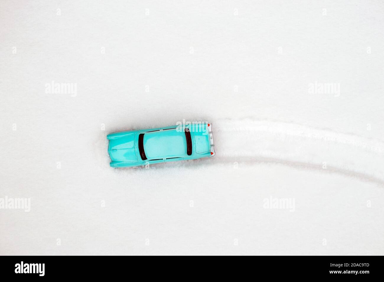 toy model of soviet popular vintage car Volga GAZ-21 rides on white ...