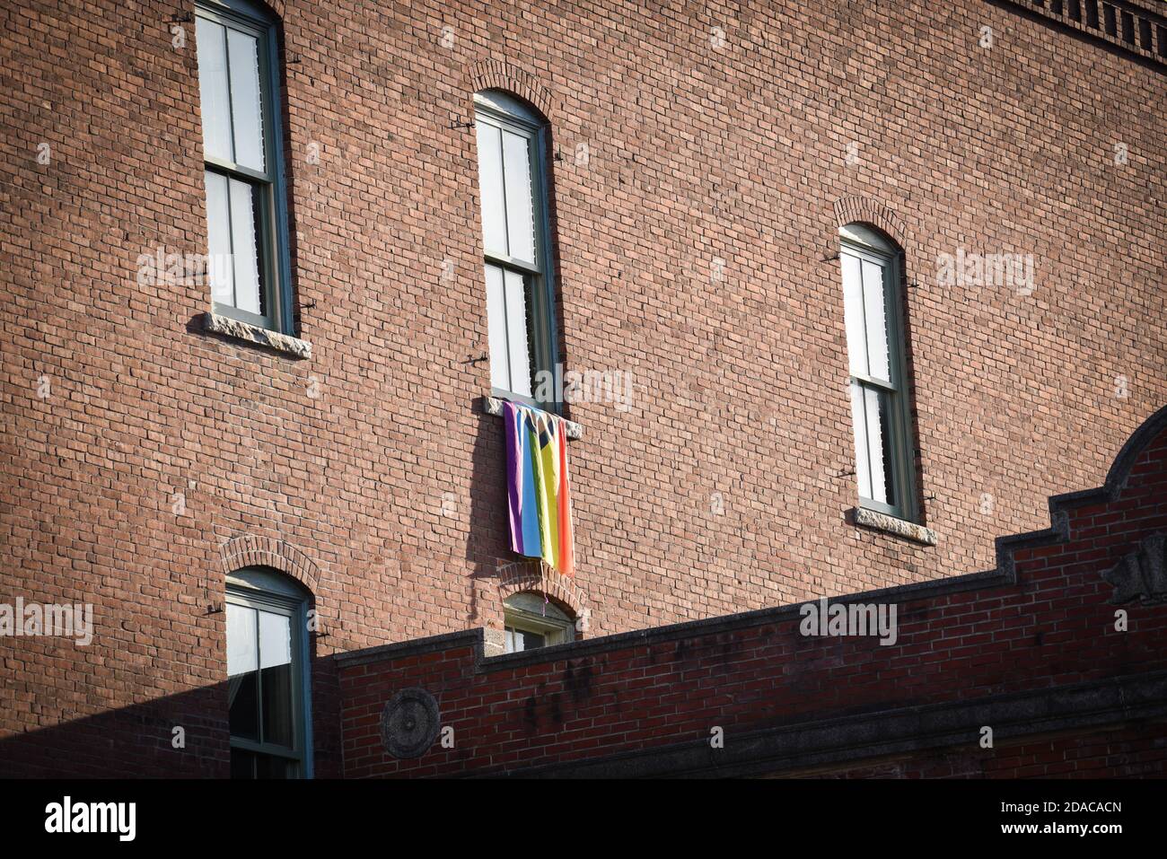 Rainbow banner on brick wall hi-res stock photography and images - Alamy