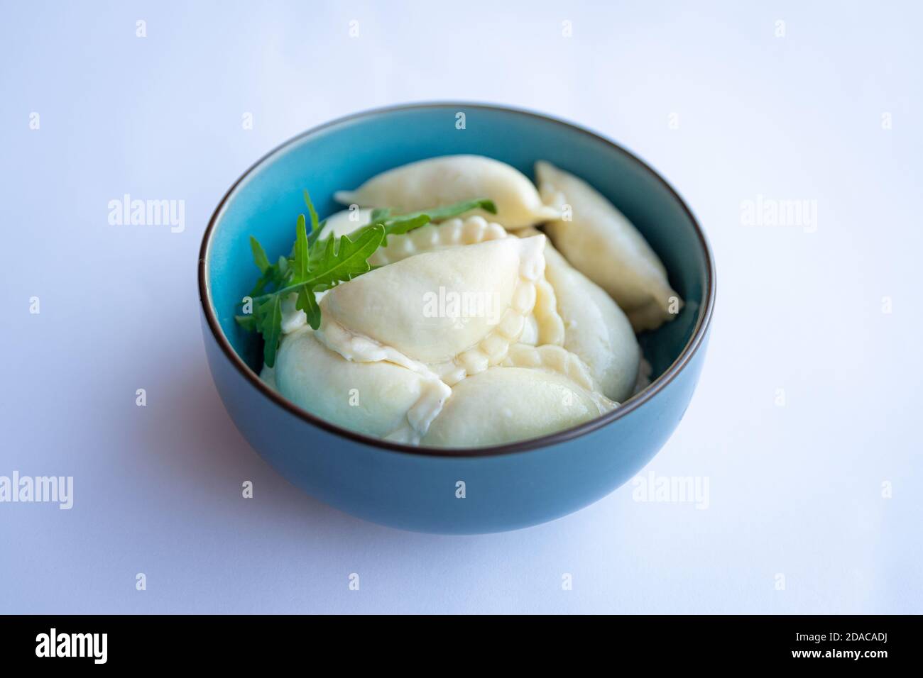 A blue bowl full of delicious dumplings Stock Photo - Alamy