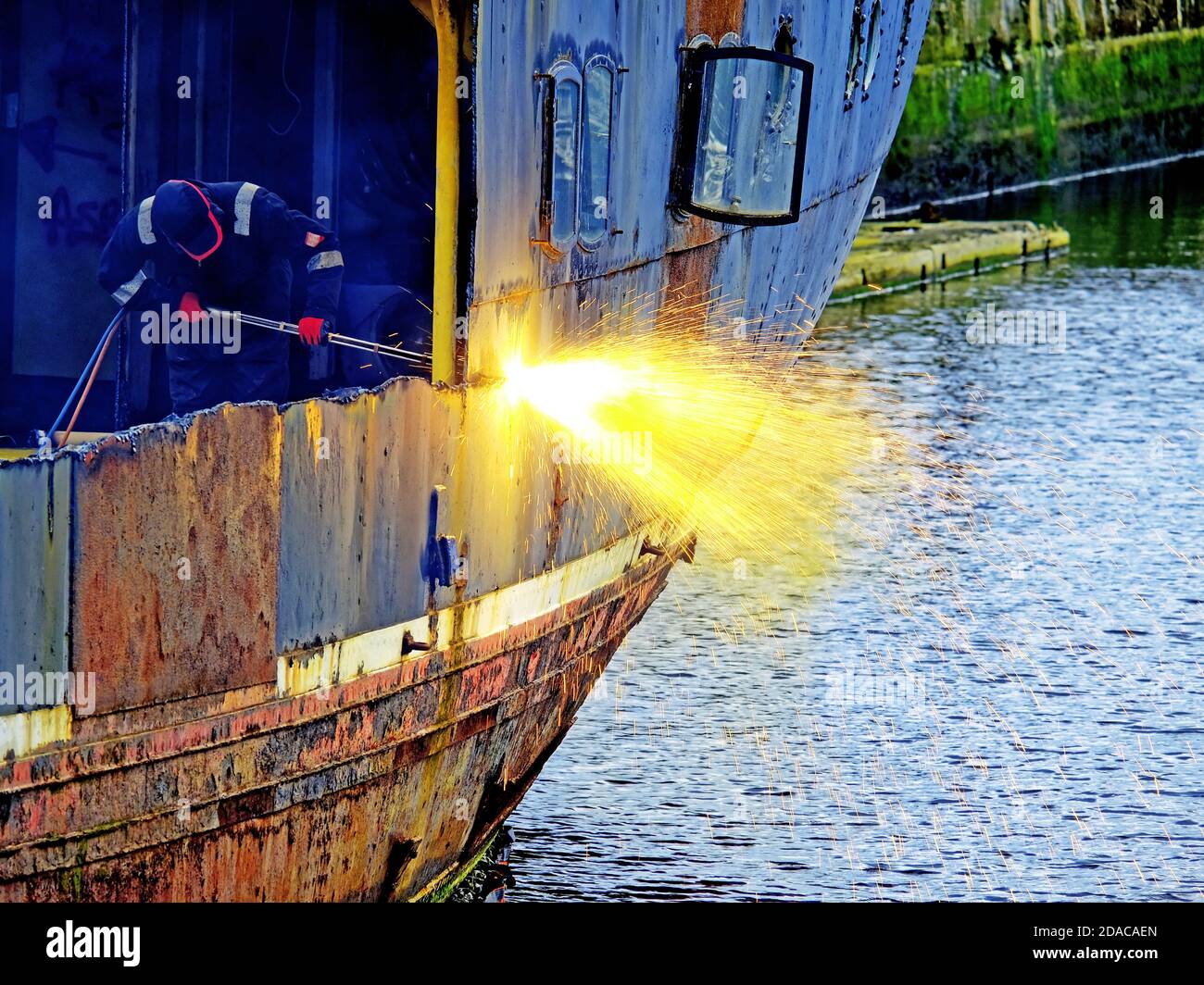 Breaking up an old ship whilst still afloat with oxy aceteline cutters ...