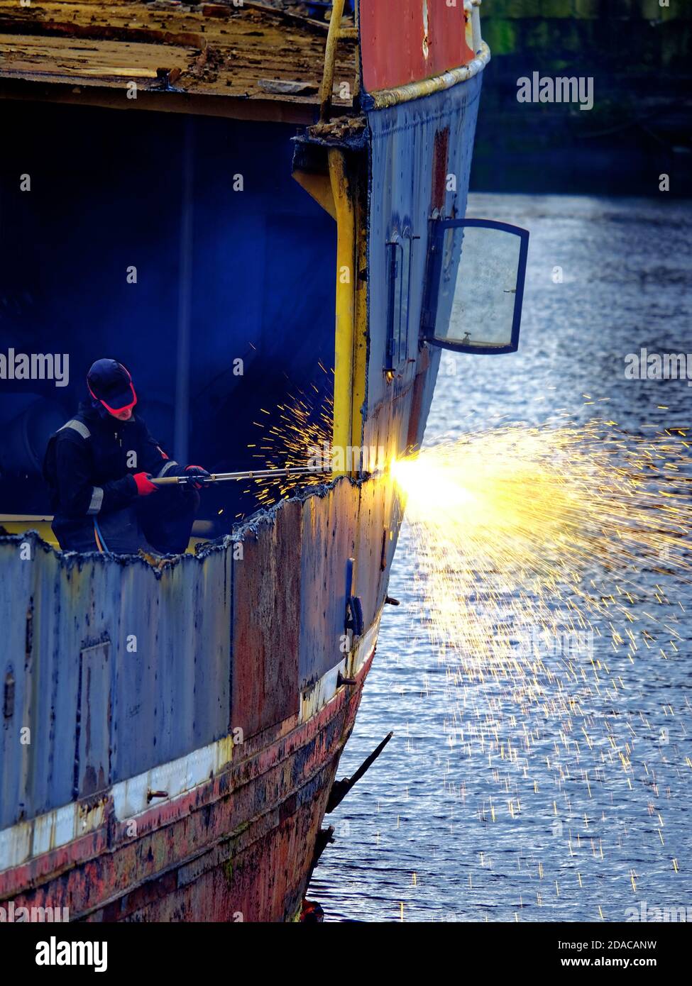 Breaking up an old ship whilst still afloat with oxy aceteline cutters ...