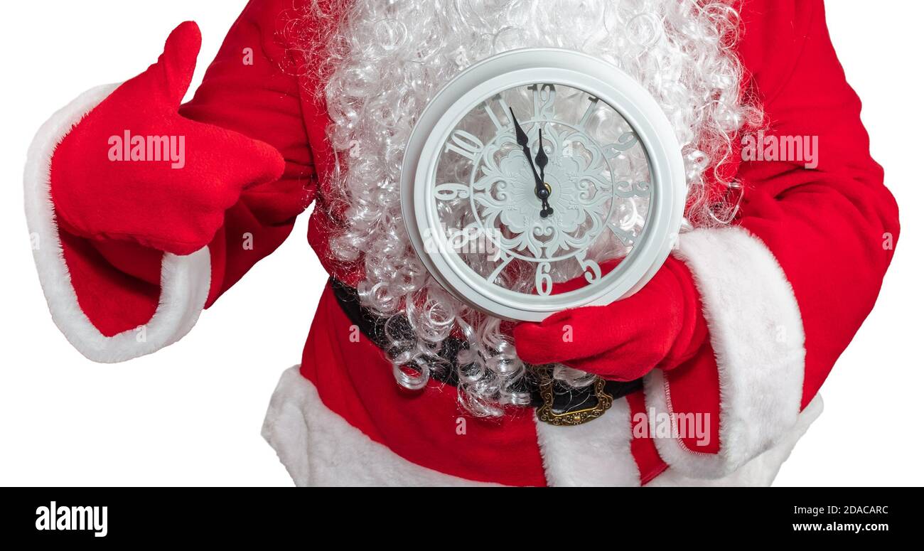 Santa Claus holding a white clock which shows five minutes to midnight ...