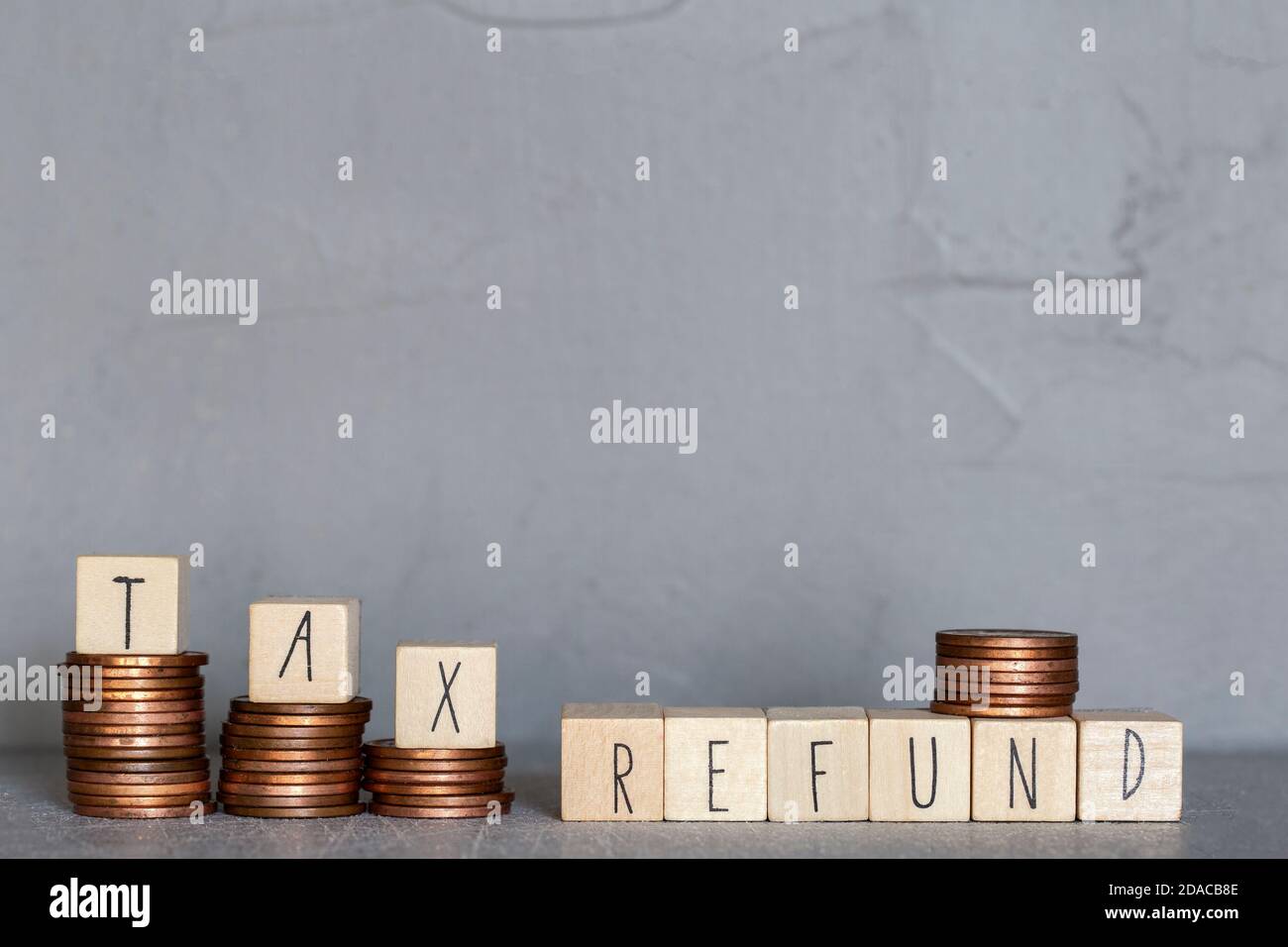 Tax refund text with wooden cubes on concrete modern background texture ...