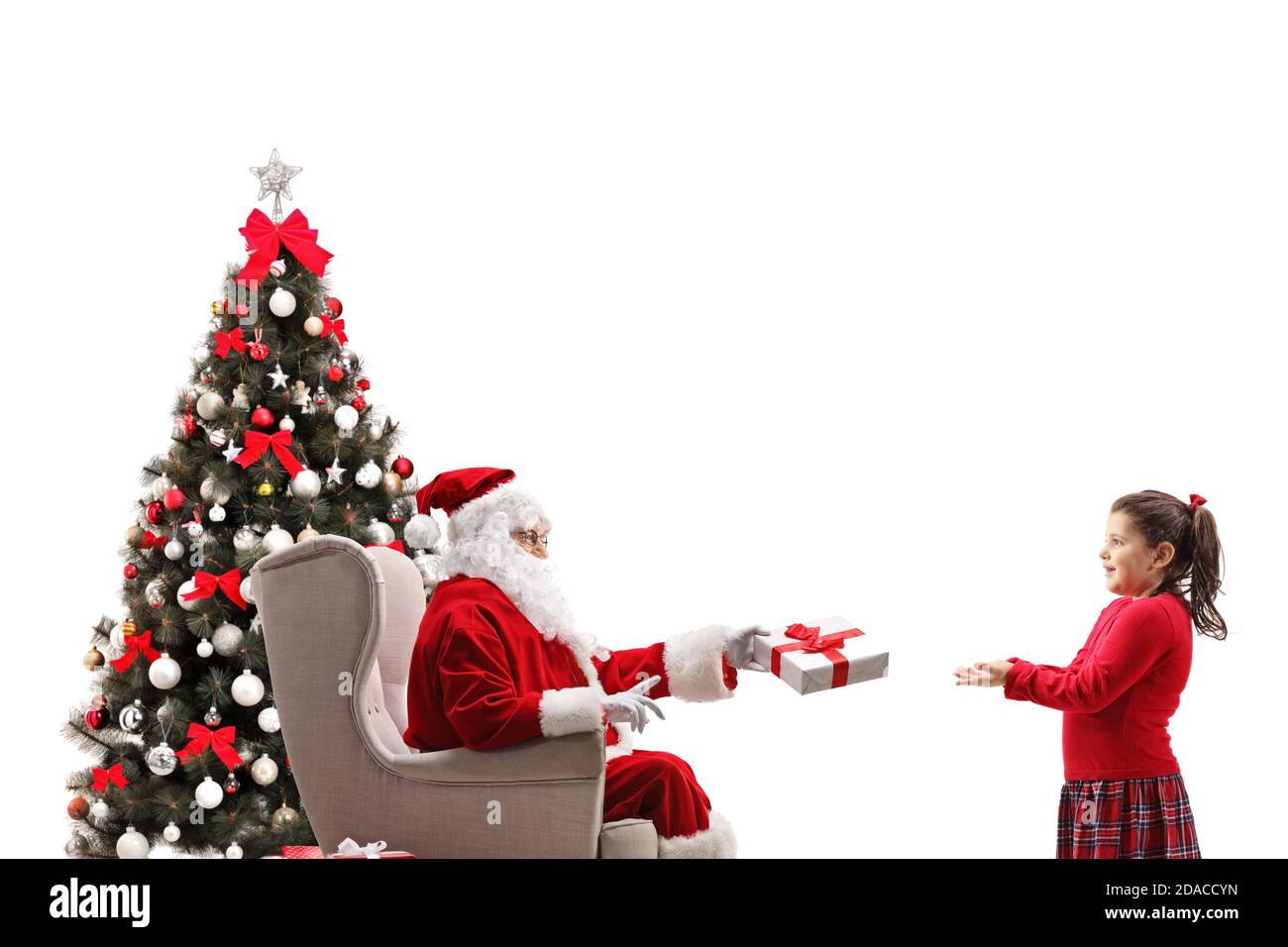 Christmas tree and Santa Claus giving a present to a happy little girl ...