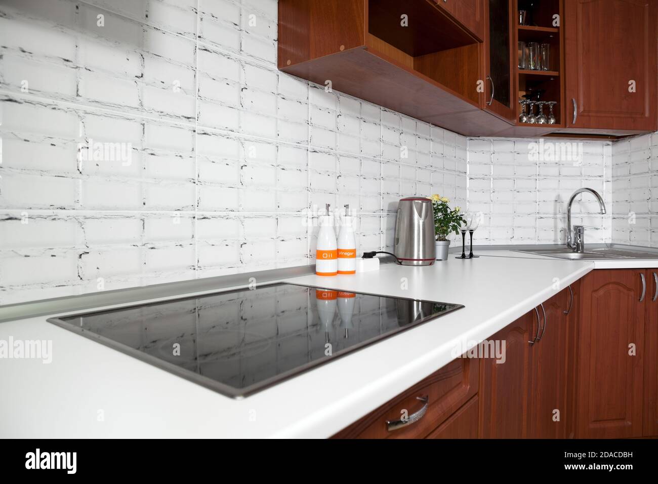 Interior of domestic kitchen with cooktop electric touch stove and long ...