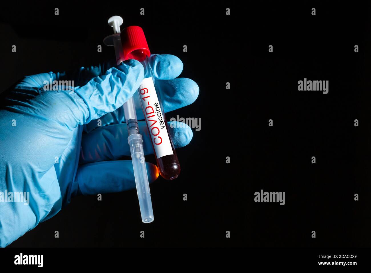 Doctor holds COVID 19 Coronavirus vaccine in his hand, infected blood ...