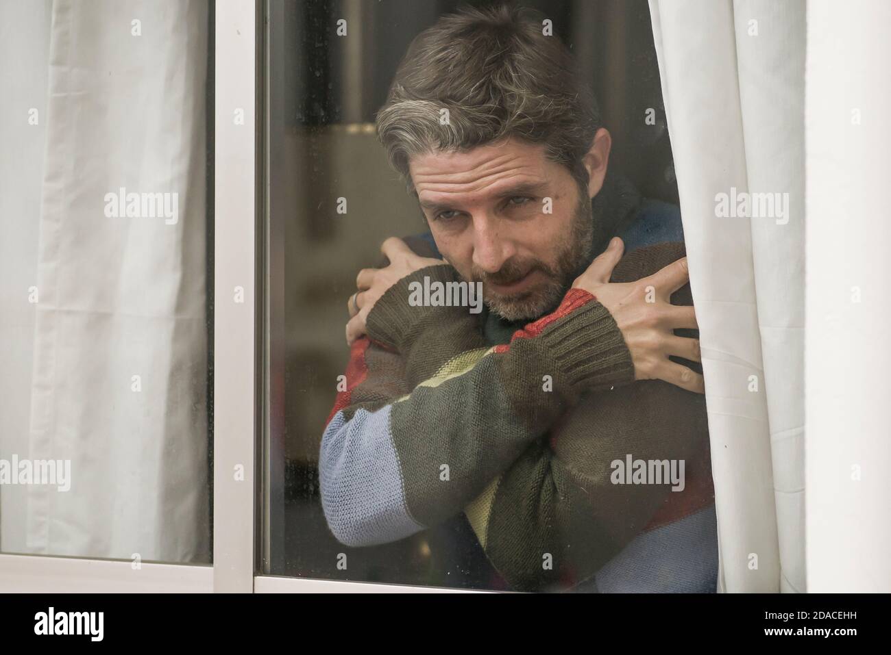 dramatic portrait of attractive sad and depressed mid adult man looking ...