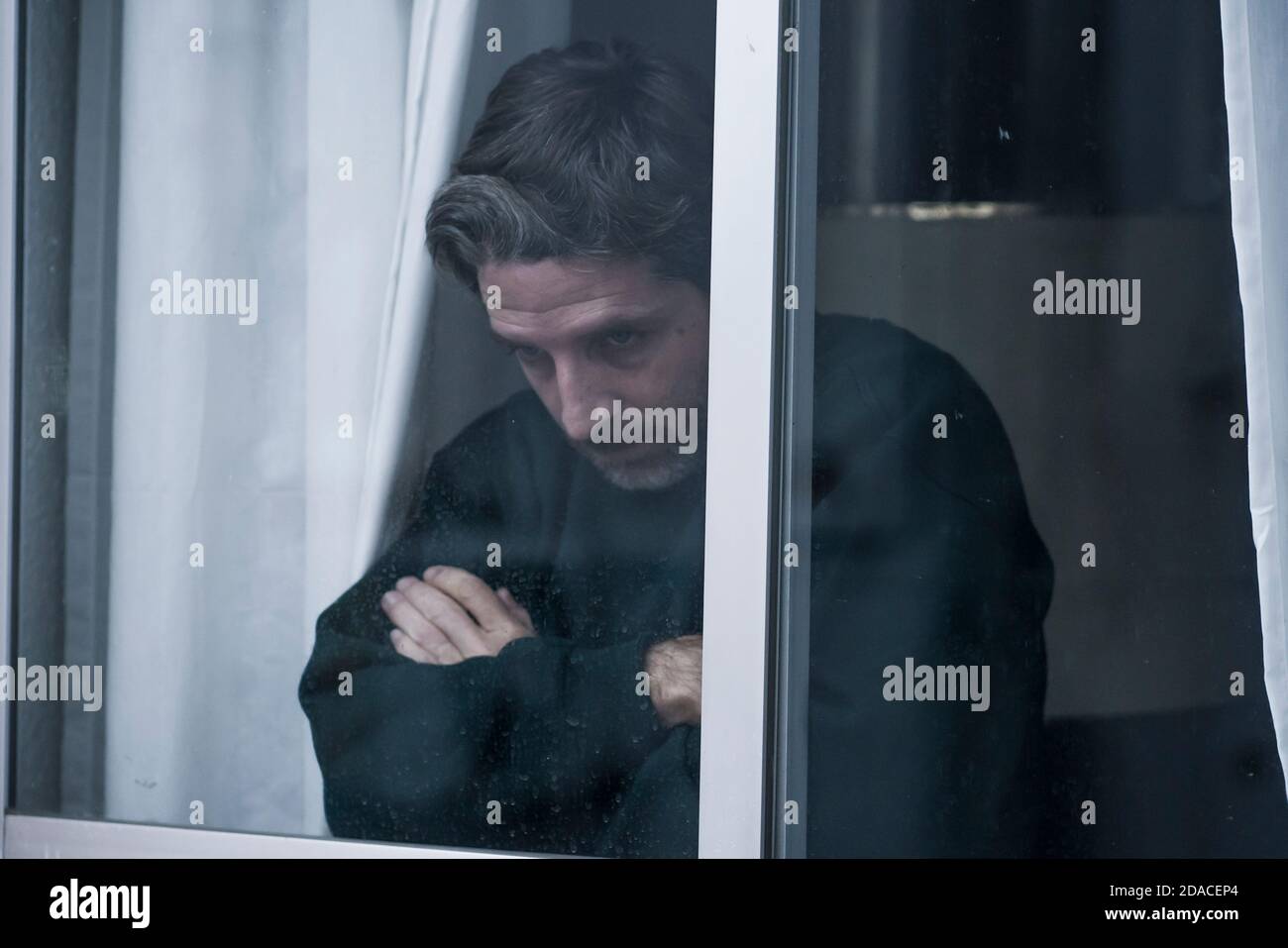 dramatic portrait of attractive sad and depressed mid adult man looking ...