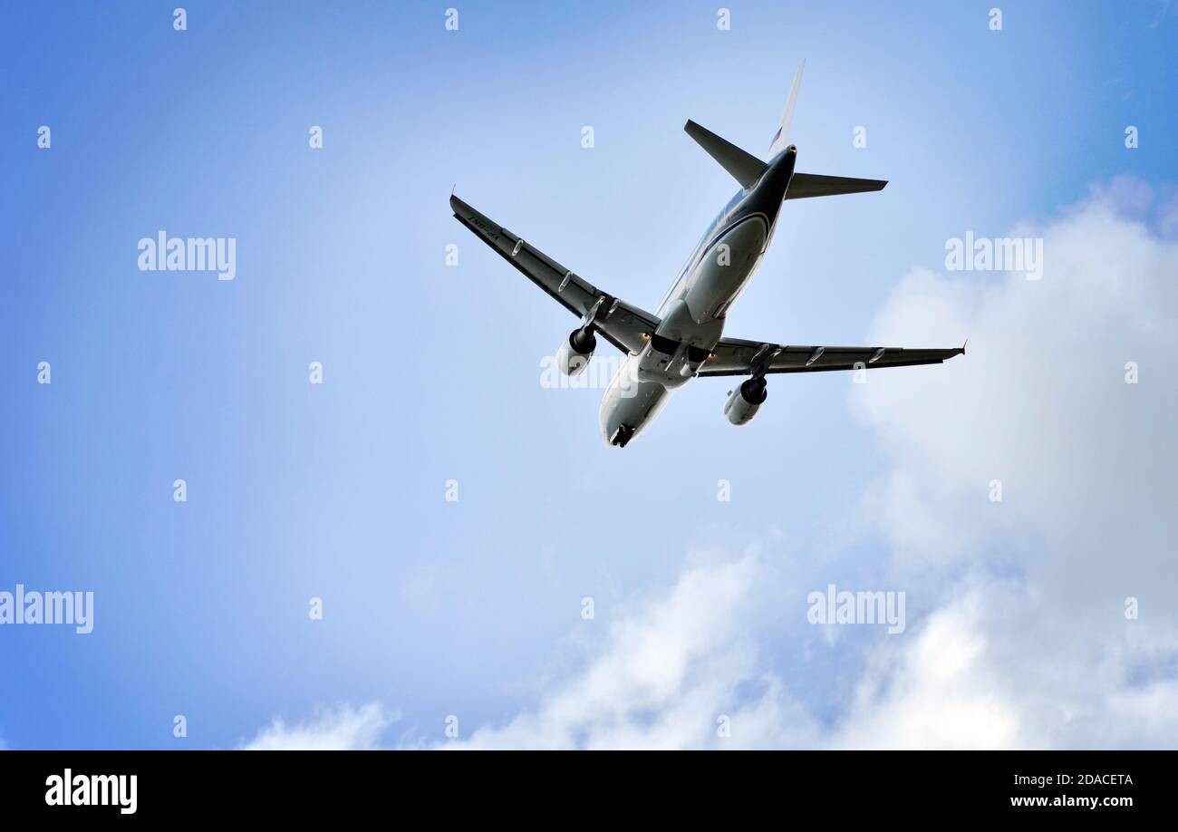 Airplane flying in the sky Stock Photo - Alamy