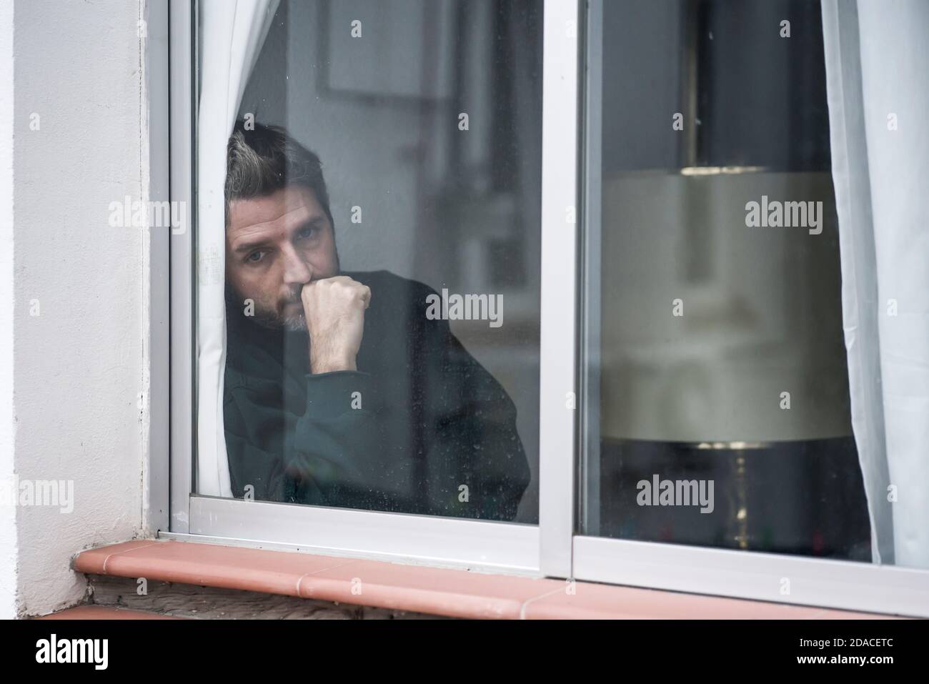 dramatic portrait of attractive sad and depressed mid adult man looking ...