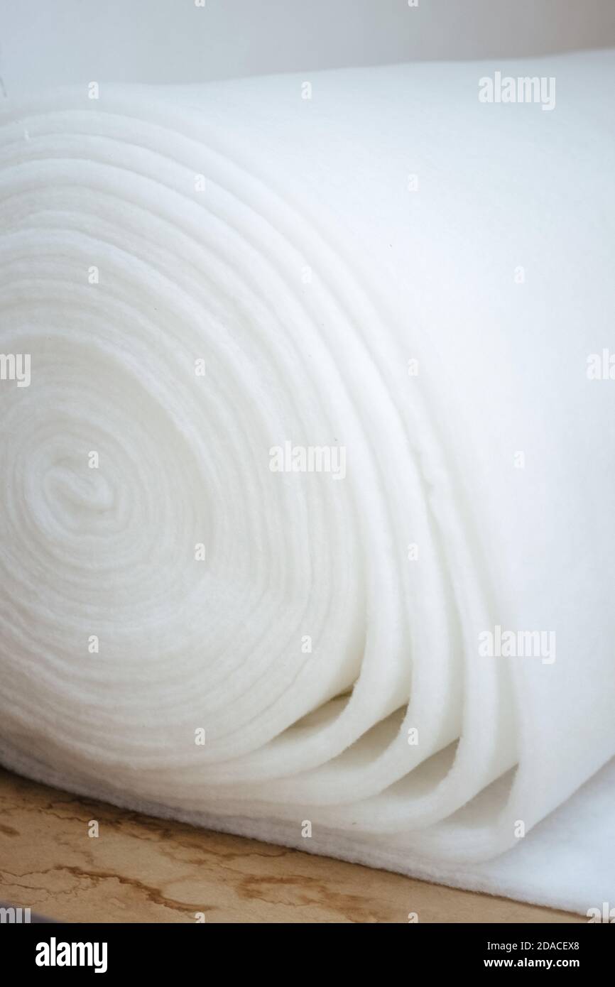 Vertical of a roll of white padding for furniture Stock Photo - Alamy
