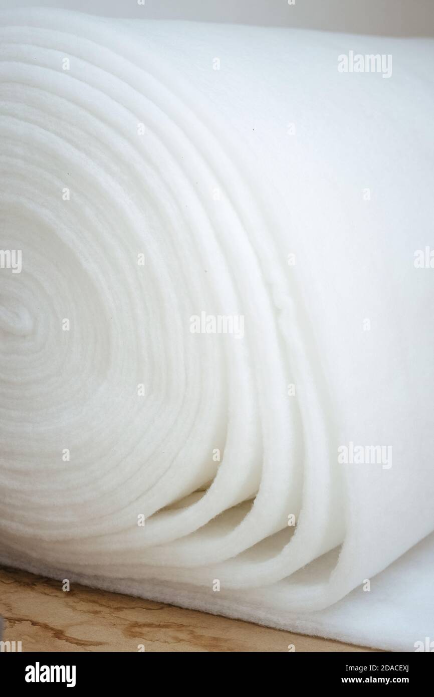 Vertical of a roll of white padding for furniture Stock Photo - Alamy