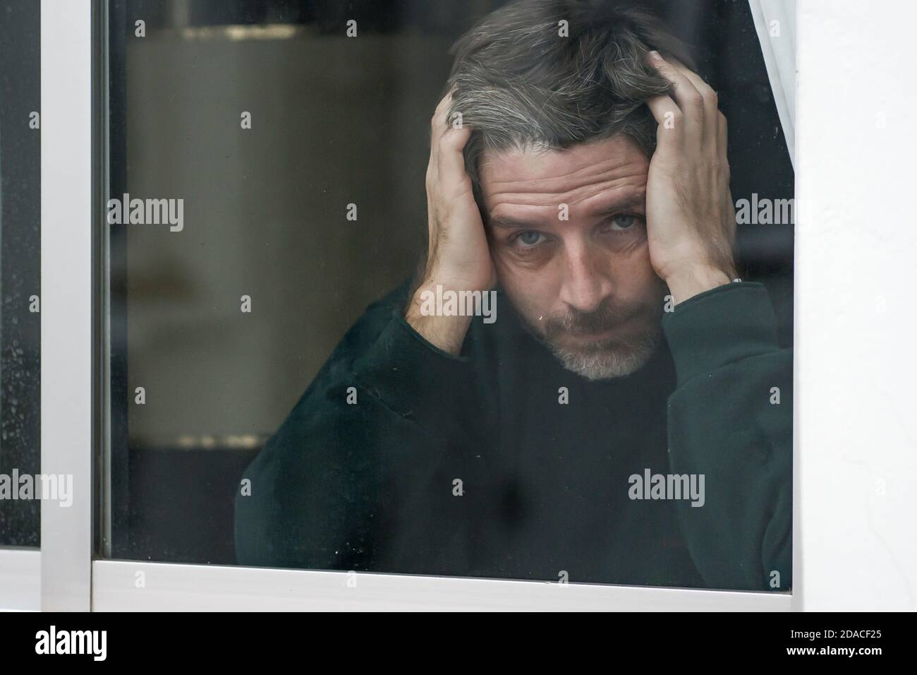 dramatic portrait of attractive sad and depressed mid adult man looking ...