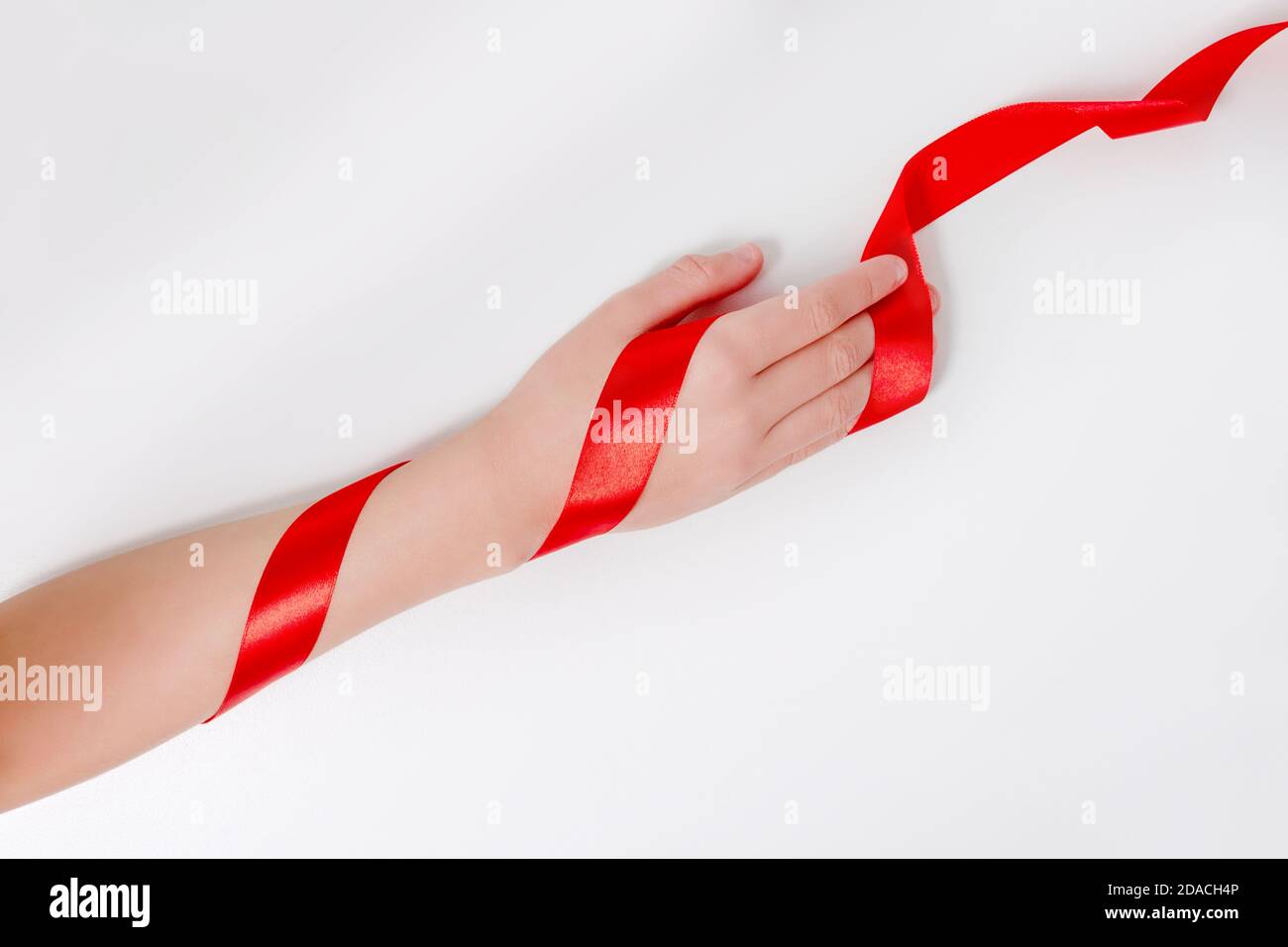 Childs hand in red ribbon. Worlds AIDS day for children all over the ...
