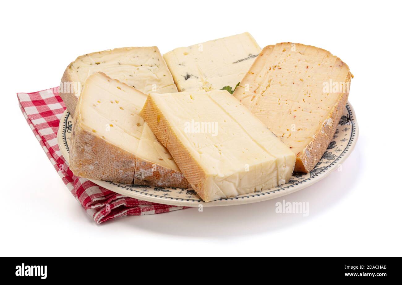Raclette cheese platter with several flavors on white background Stock ...