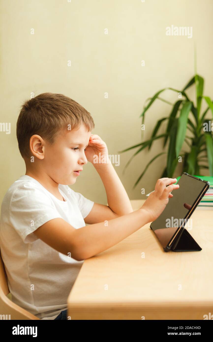 Child using gadgets for study. Education and distance learning concept ...