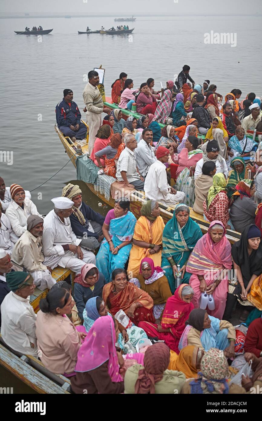 Varanasi, India, January 2009. A boat full of pilgrims in a ghat on the ...