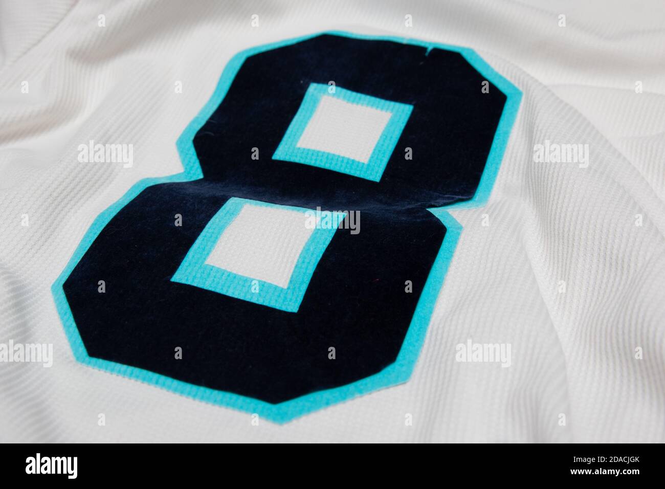 Large black number eight with light blue outline on a white shirt Stock ...