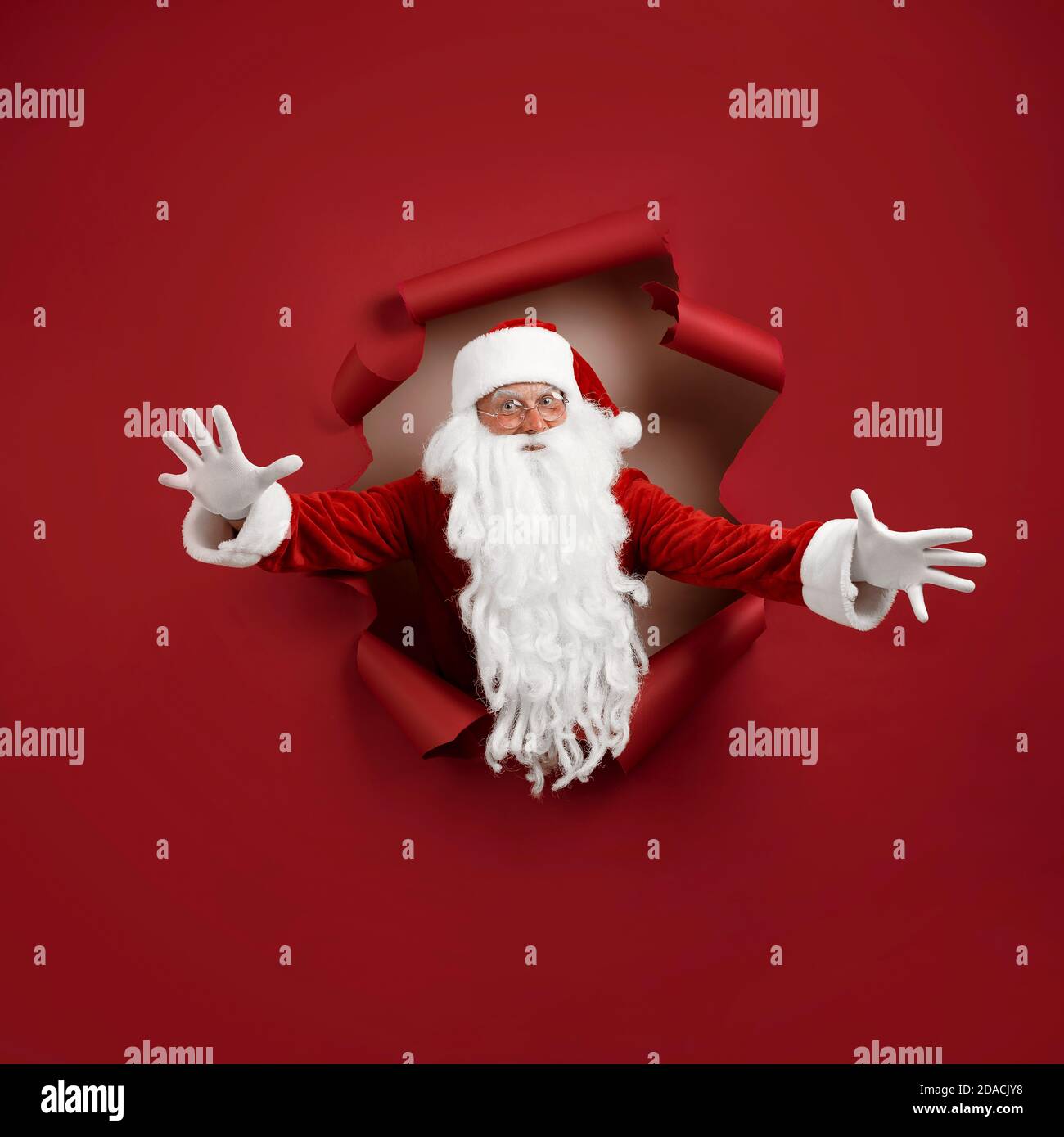 Santa man spread his arms in different directions and look emotionally ...