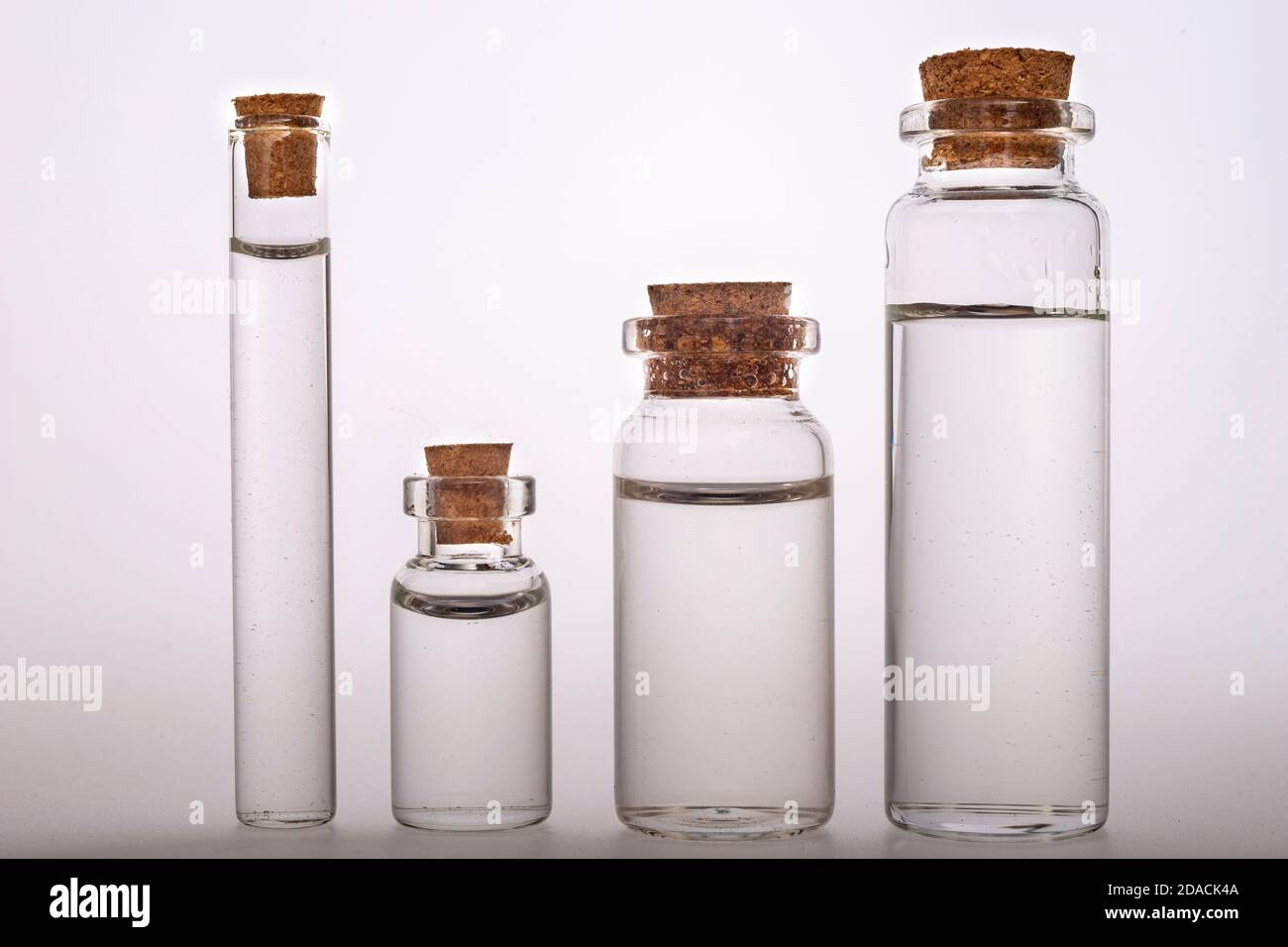 Glass bottles with liquid closed with a stopper. Container for storing ...