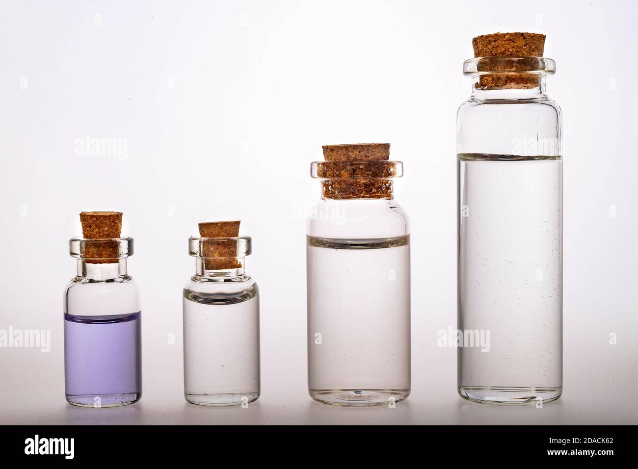 Glass bottles with liquid closed with a stopper. Container for storing ...