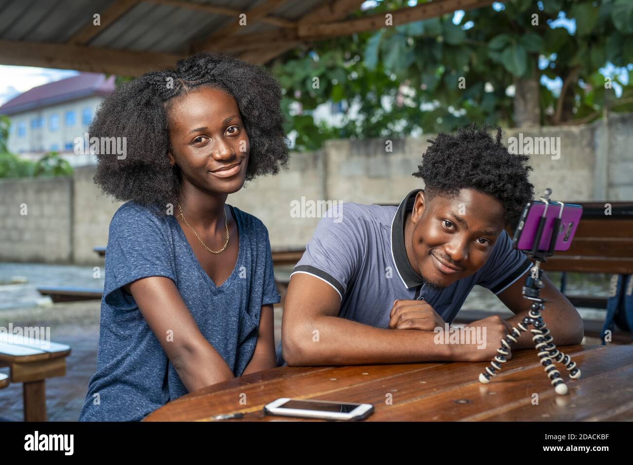 African friends taking part in an online conference with smartphone ...