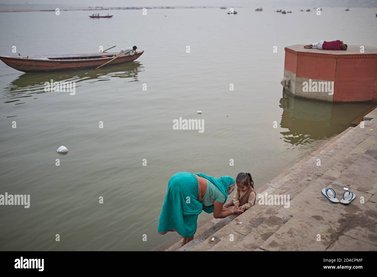 Varanasi, India, November 2015. A mother with her daughter on a step in ...