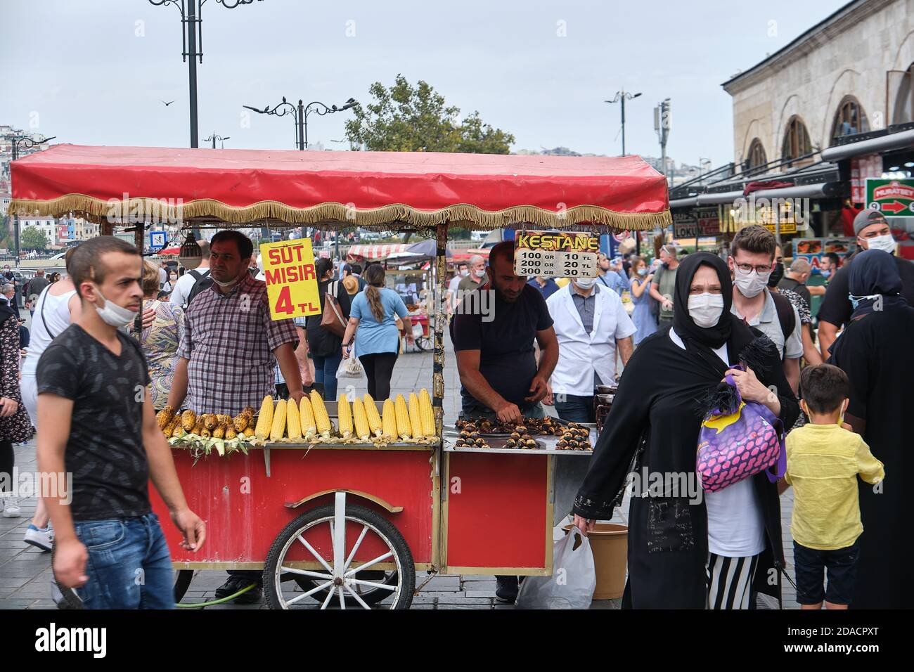 Toasted corn on the cob and roasted chestnuts mobile stall in a busy ...