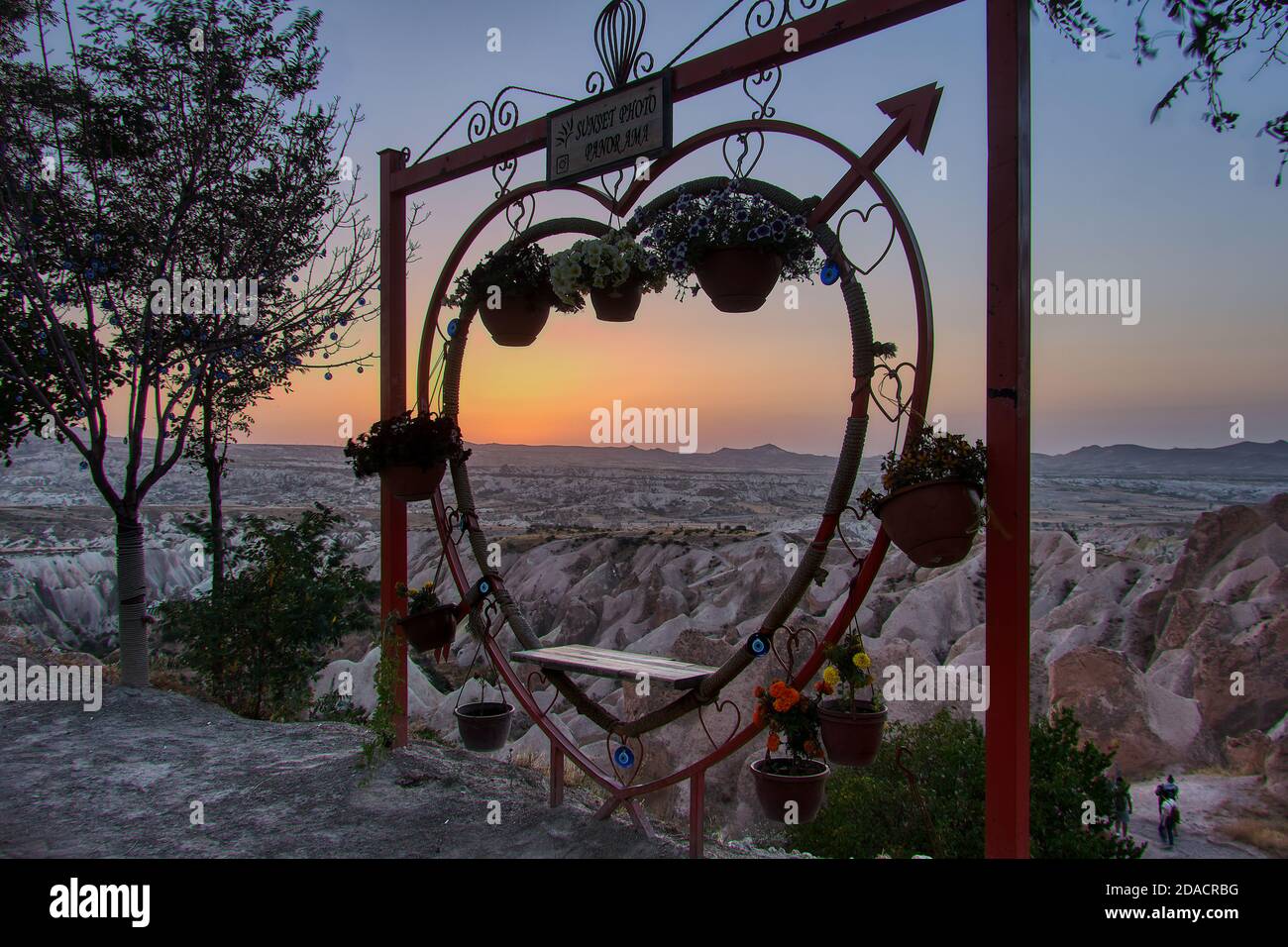 Sunset view through a love heart seat of the Cappadocia rock formations ...