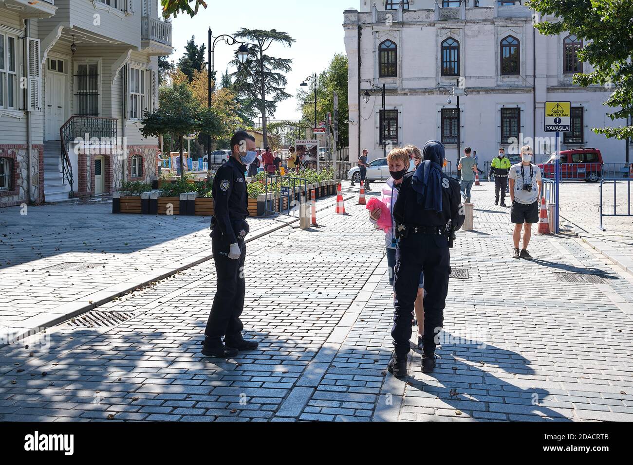 Face mask wearing Turkish police man and woman checking people at ...