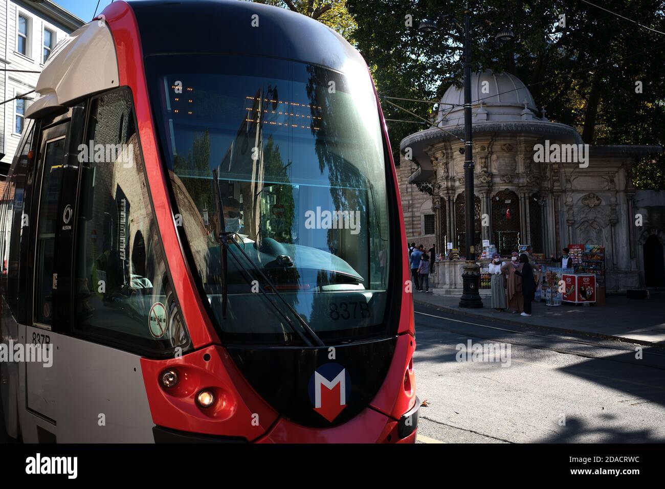 Turkish tram driver wearing a face mask driving a tram through the ...