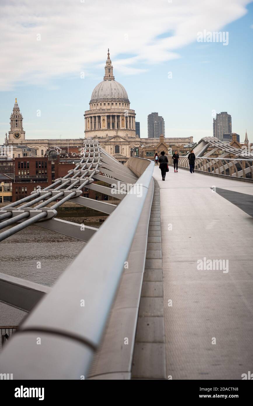 St Pauls Cathedral looking over the millennium bridge people crossing ...