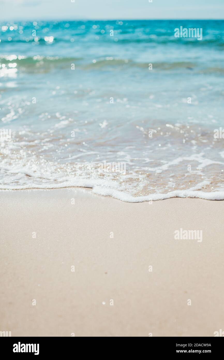 Soft blue ocean wave on sandy beach. Background Stock Photo - Alamy