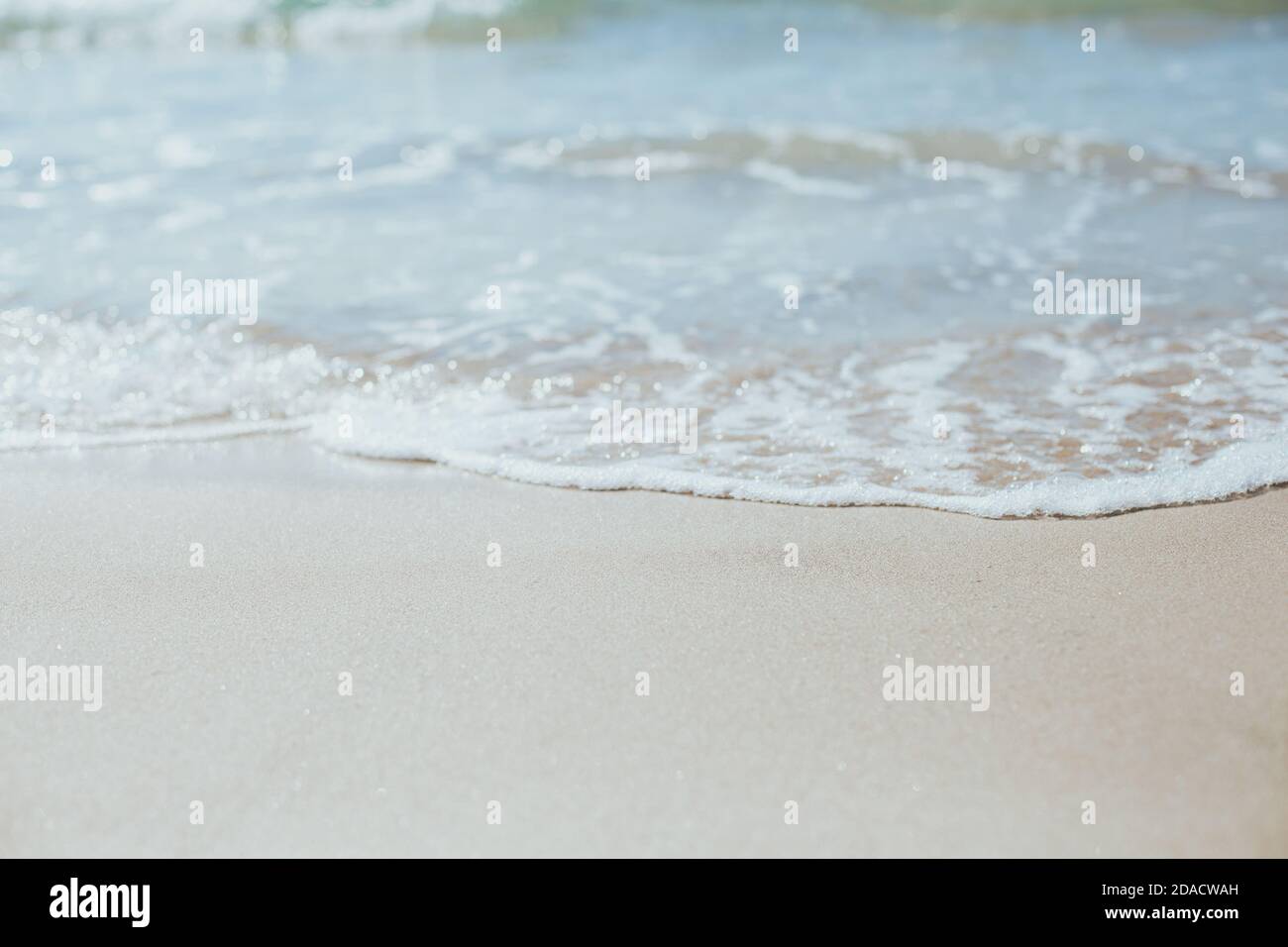 Soft blue ocean wave on sandy beach. Background Stock Photo - Alamy