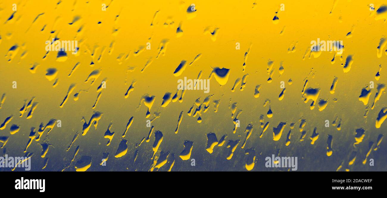 Background yellow glass in rain drops close-up Stock Photo - Alamy