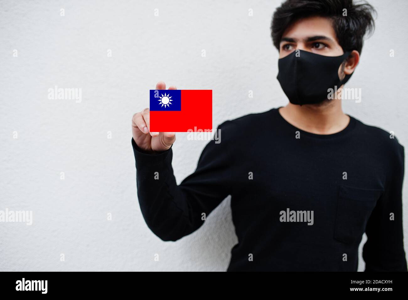 Asian man wear all black with face mask hold Taiwan flag in hand ...