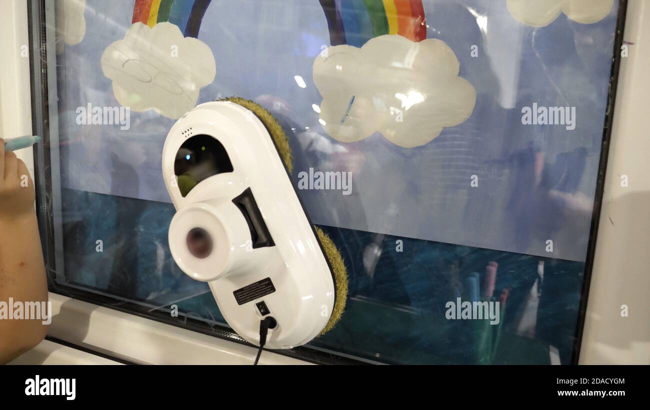 Vacuum cleaner robot cleaning window Stock Photo - Alamy