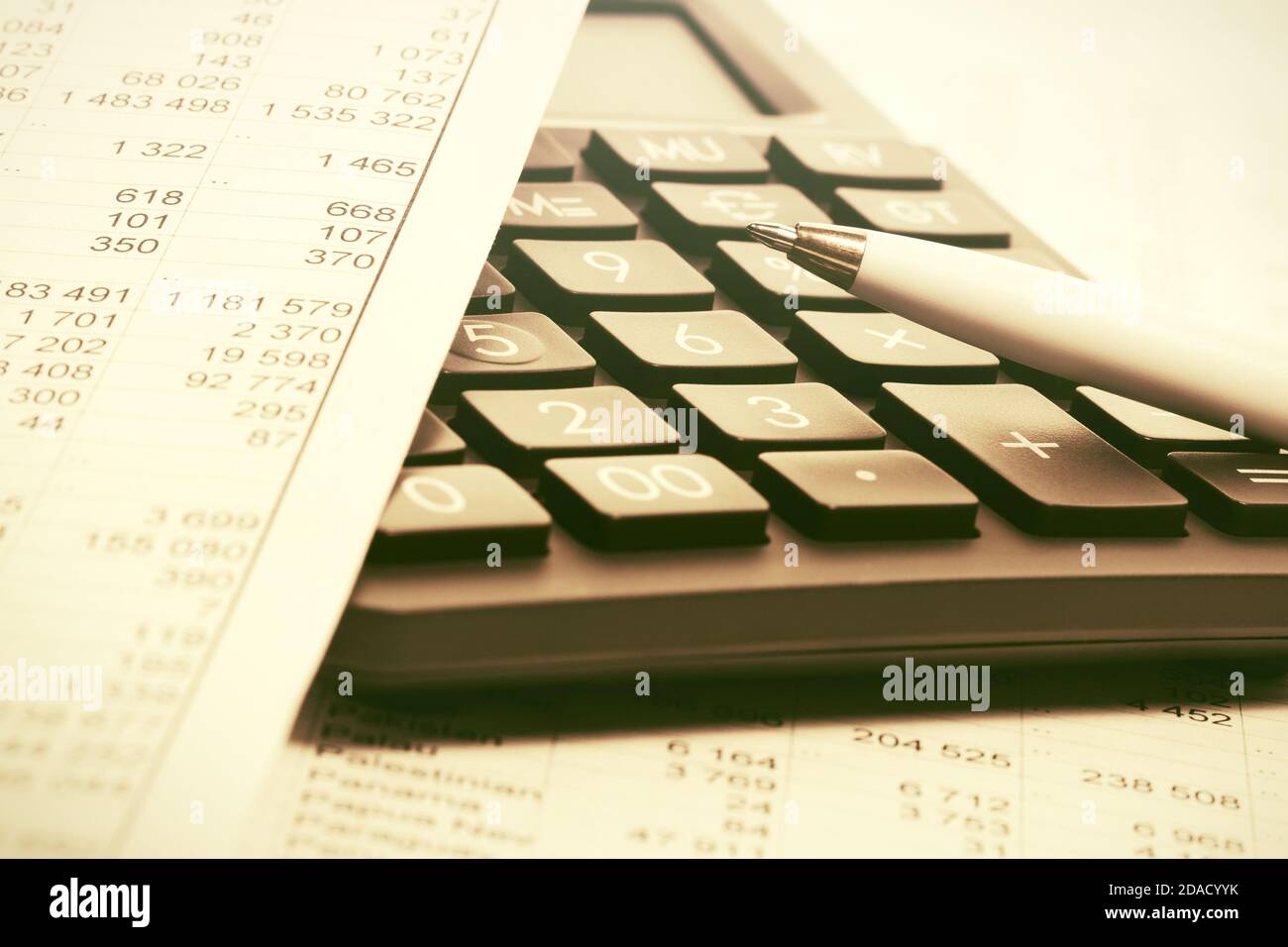 Financial accounting Pen and calculator on balance sheets Stock Photo ...