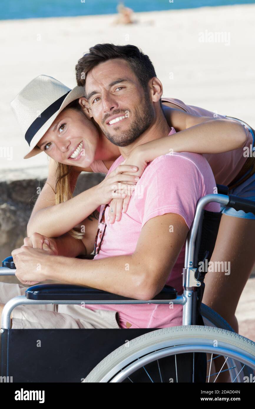 Woman hugging man in wheelchair hi-res stock photography and images - Alamy