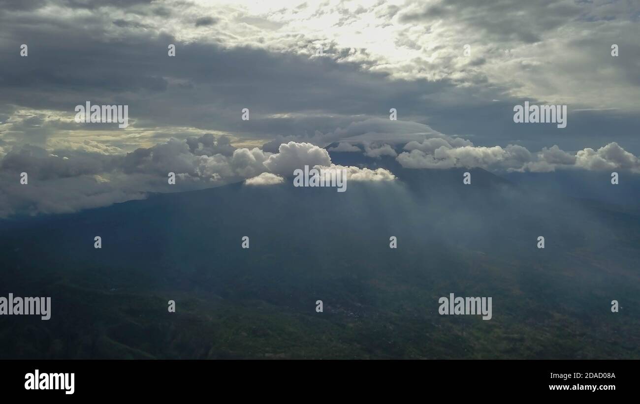 volcano with cloudy clear sky. Mount Merapi in Indonesia. Cloudy sky ...