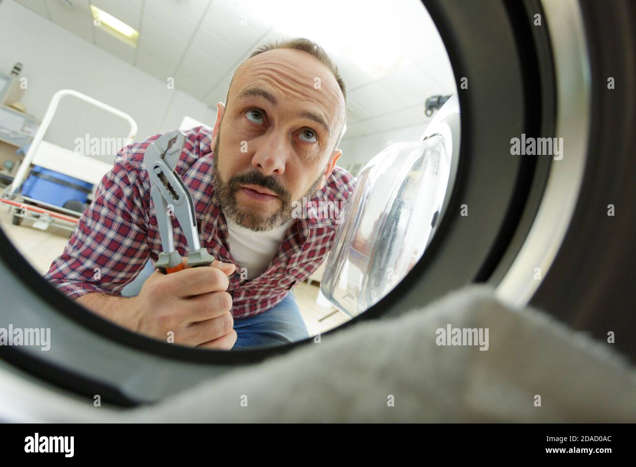 a technician repairing washing machine Stock Photo - Alamy