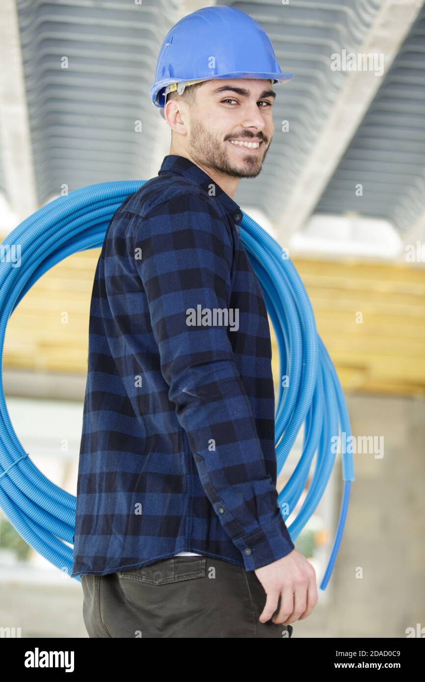 a young builder with pipes Stock Photo - Alamy
