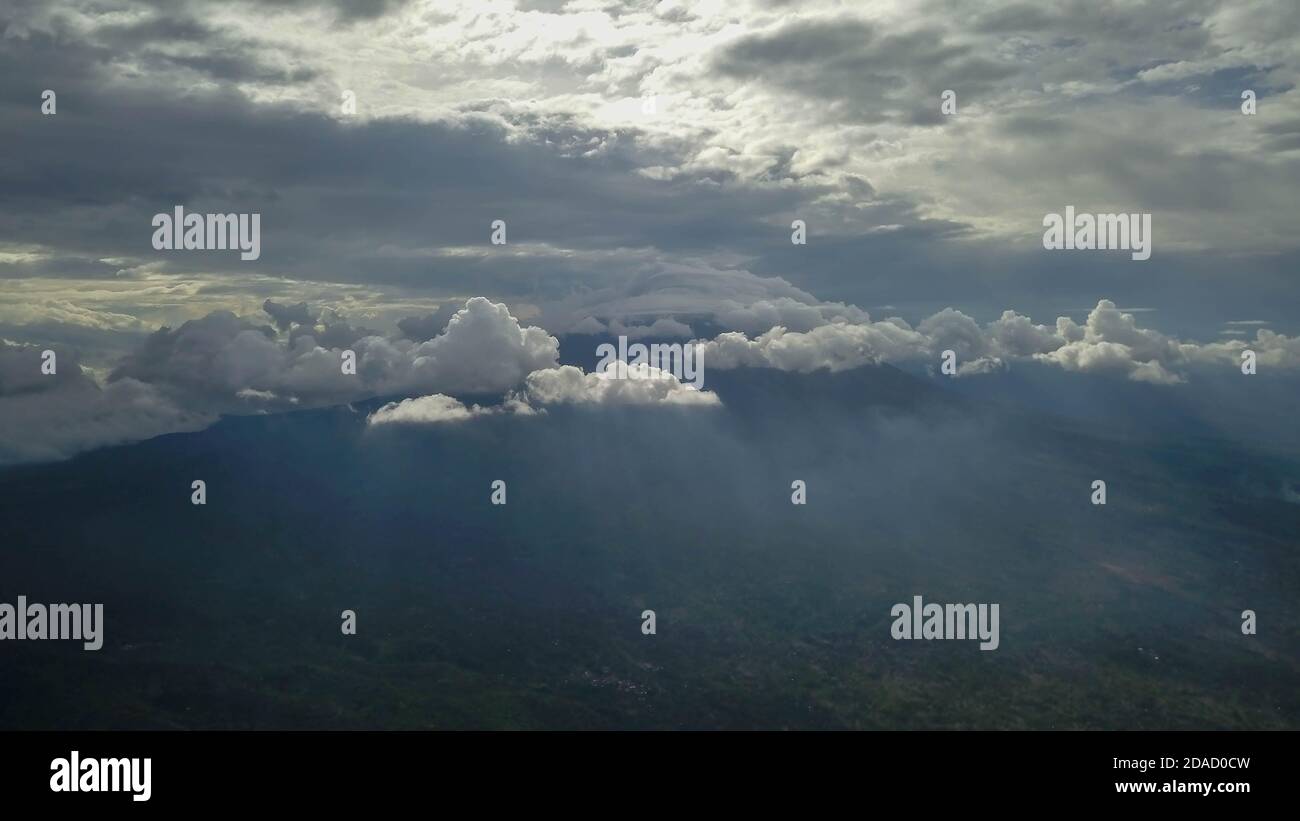 volcano with cloudy clear sky. Mount Merapi in Indonesia. Cloudy sky ...