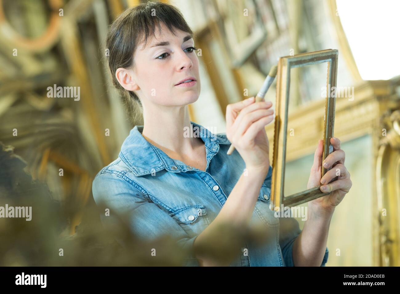 portrait of woman painting a frame Stock Photo - Alamy