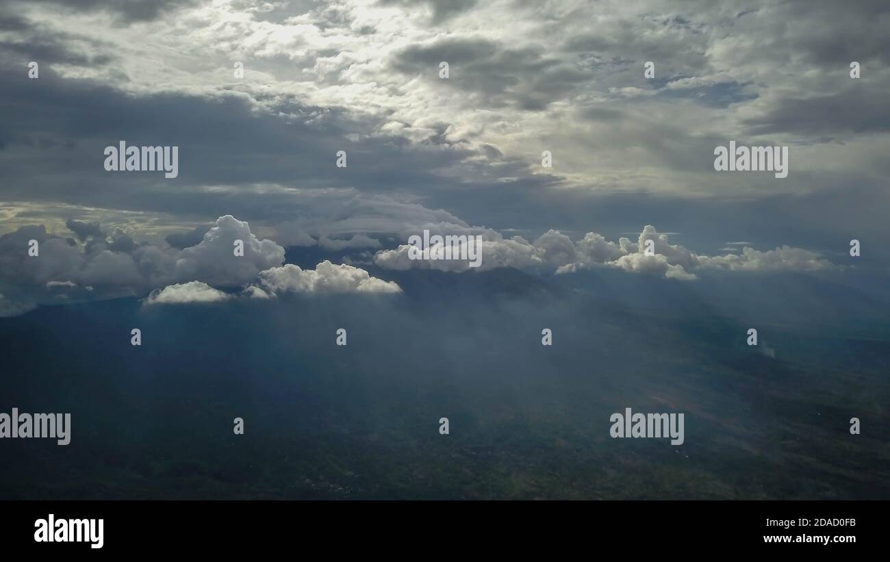 volcano with cloudy clear sky. Mount Merapi in Indonesia. Cloudy sky with a volcano in the ...