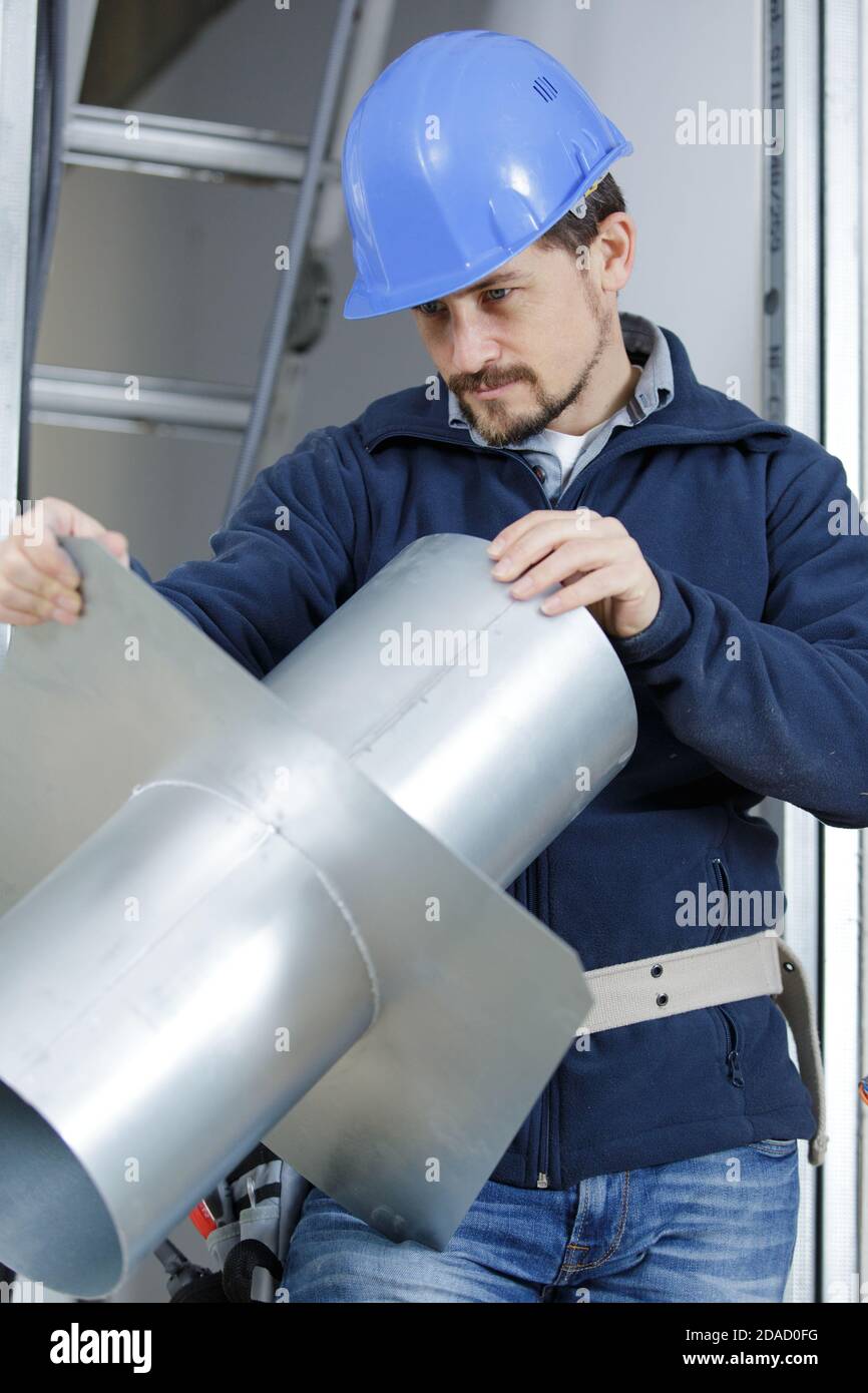 construction of metal pipes and a builder Stock Photo - Alamy