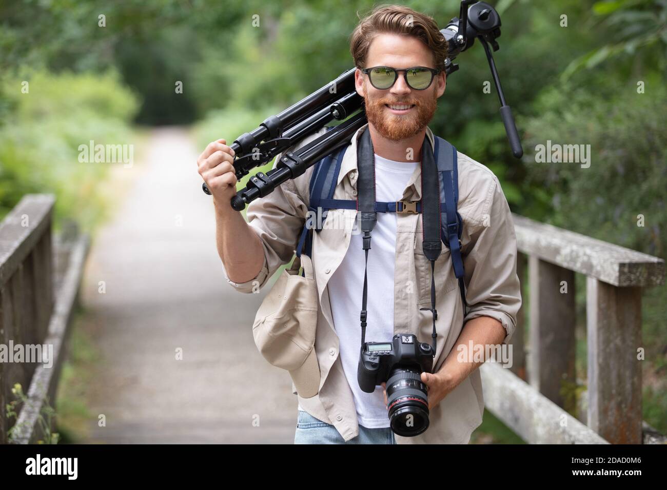 Holding tripod hi-res stock photography and images - Alamy